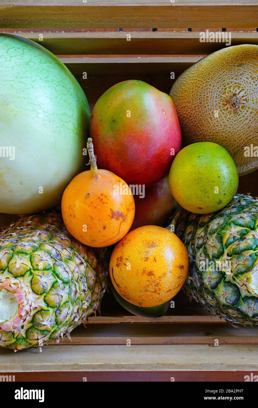 Crate of fresh tropical fruit including pineapple and mango Stock Photo ...
