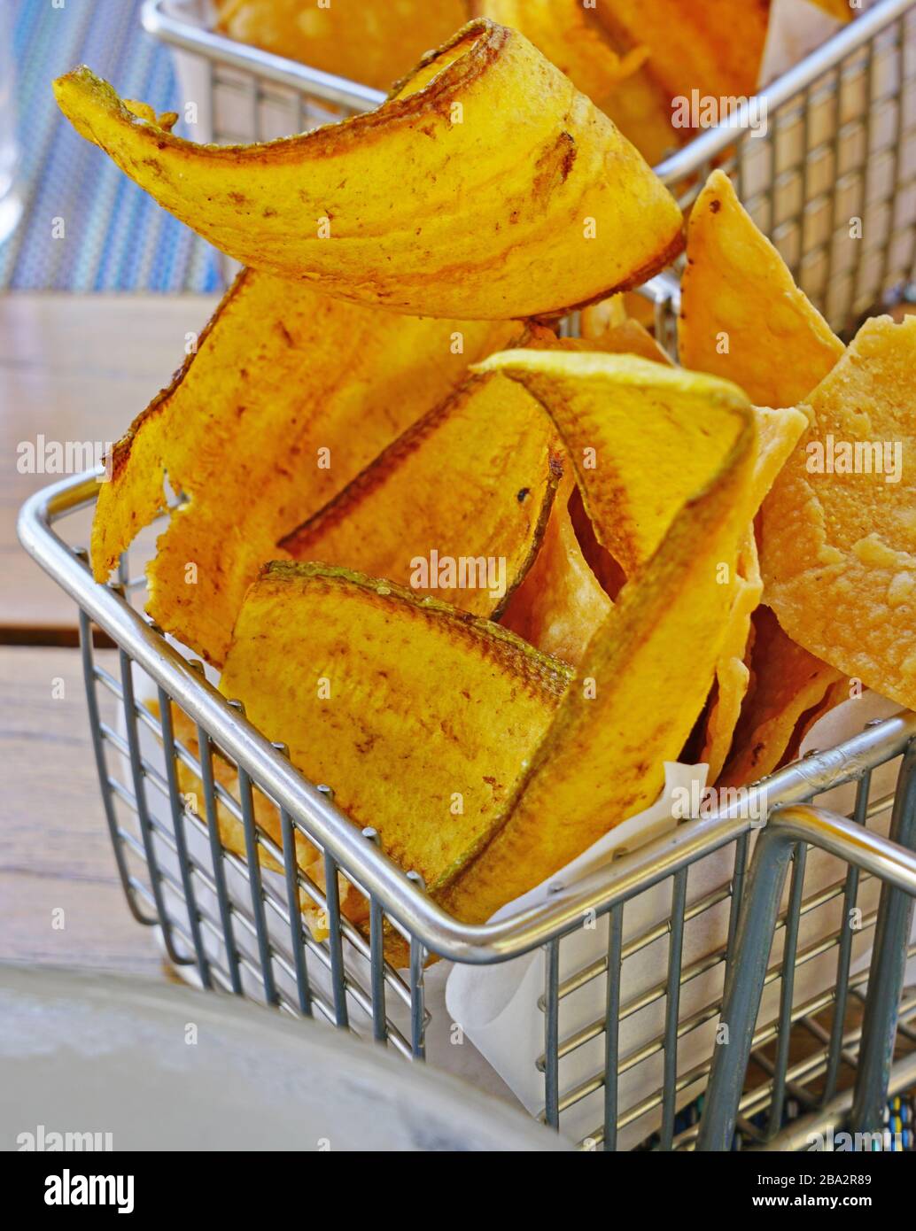 Basket of crunchy plantain chips Stock Photo - Alamy