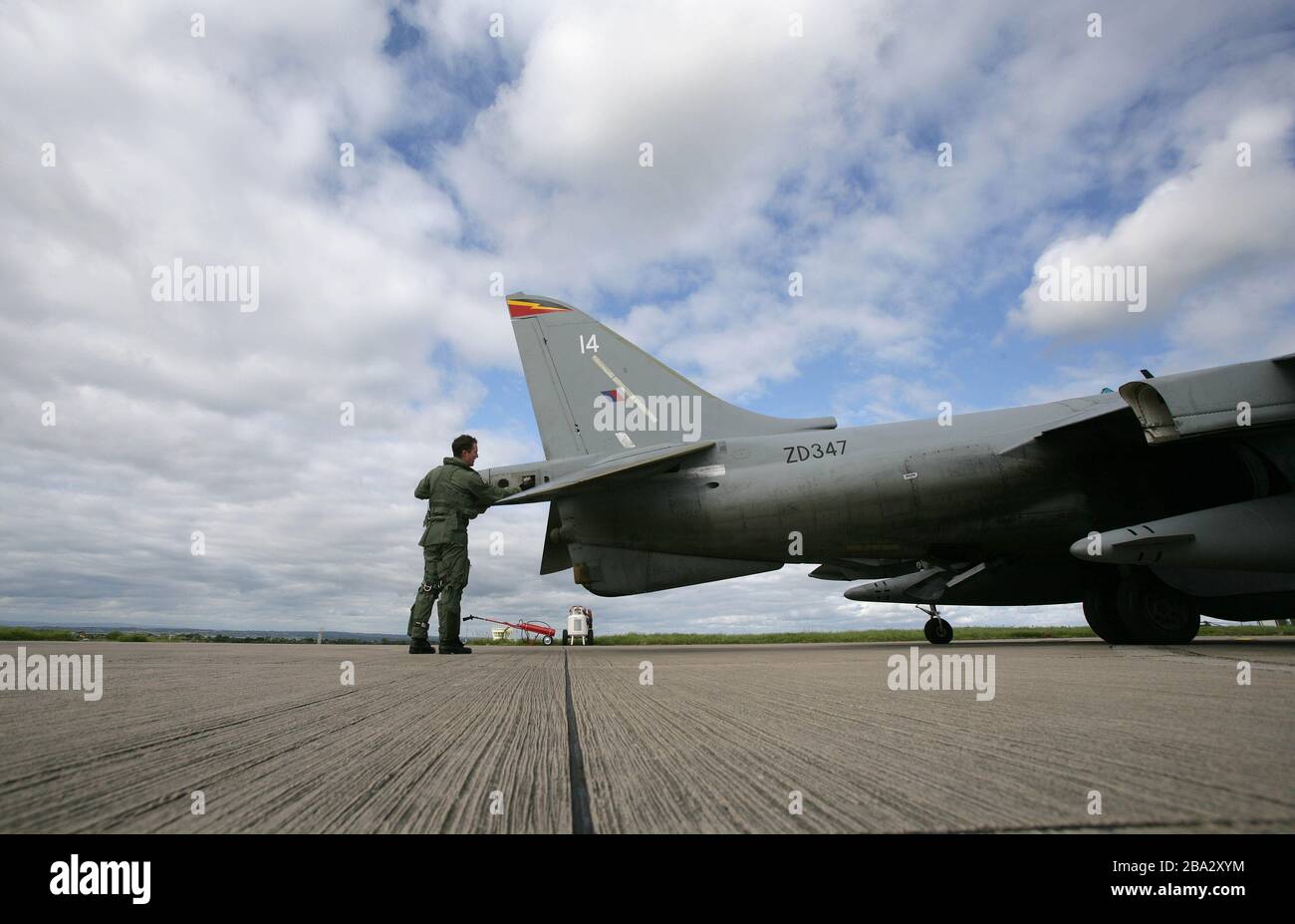 Flight Lieutenant Andy Chisholm, checks over his RAF Harrier before the ...