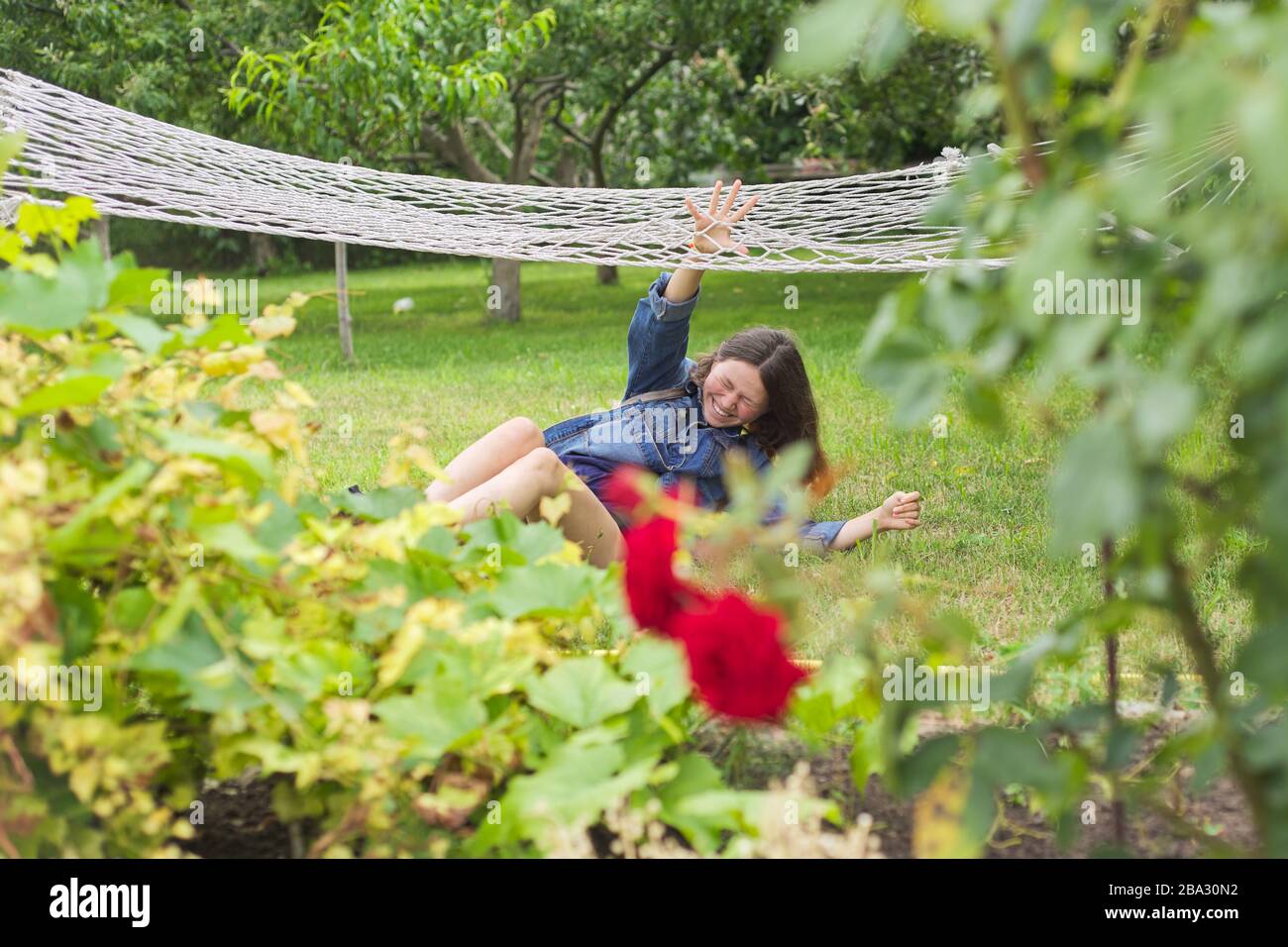 Teen girl falling from hammock, spring garden background Stock Photo ...