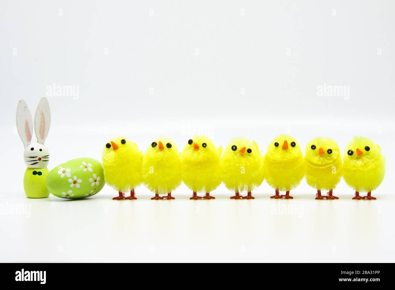 Cute little Easter chicks standing in a row with Easter bunny and egg ...