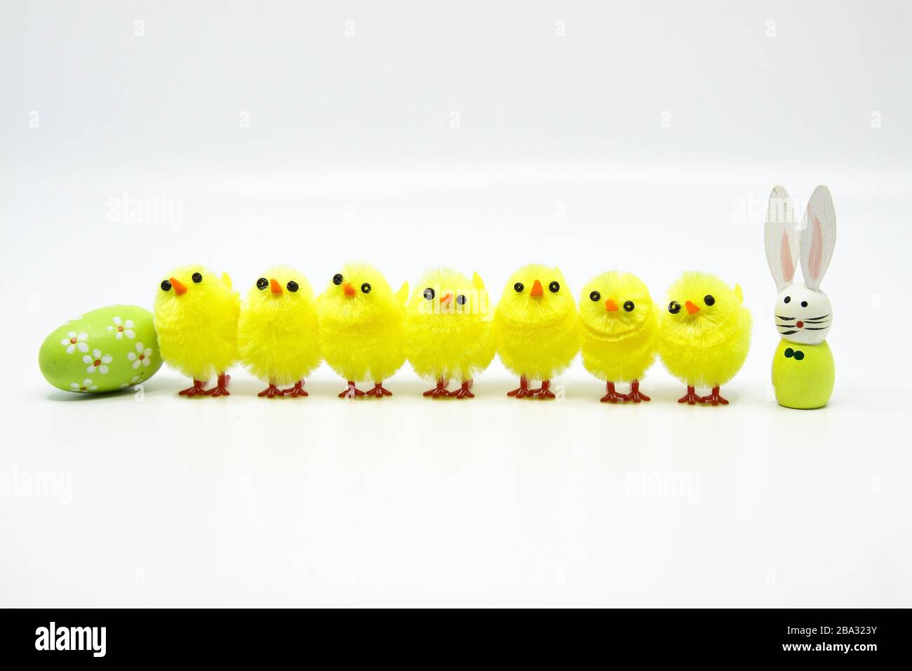 Cute little Easter chicks standing in a row with Easter bunny and egg ...