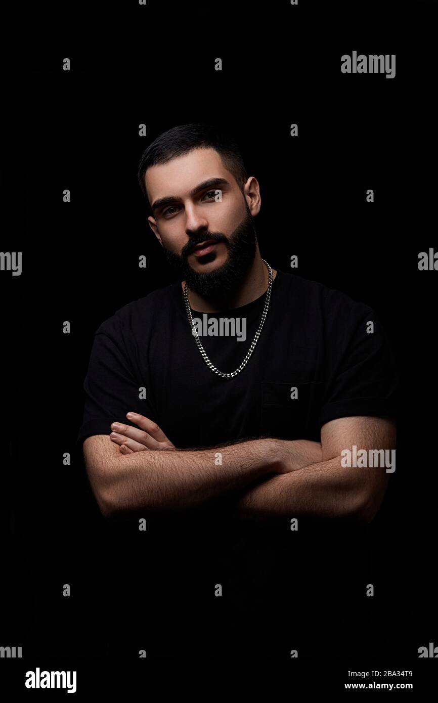 a close-up dramatic portrait of a young serious guy, musician, singer ...