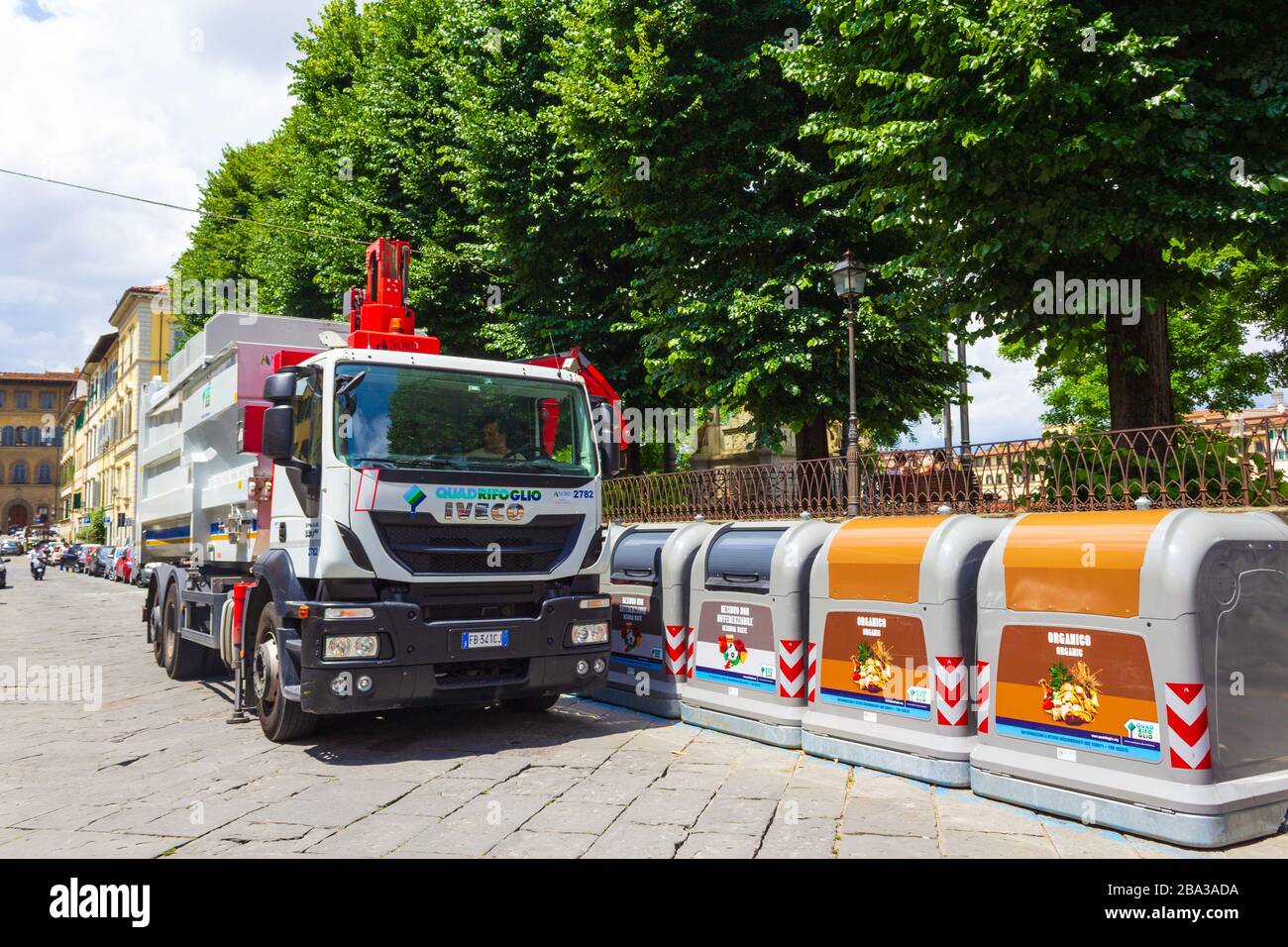 Garbage truck stopped emptying a trash bins on the street in the ...
