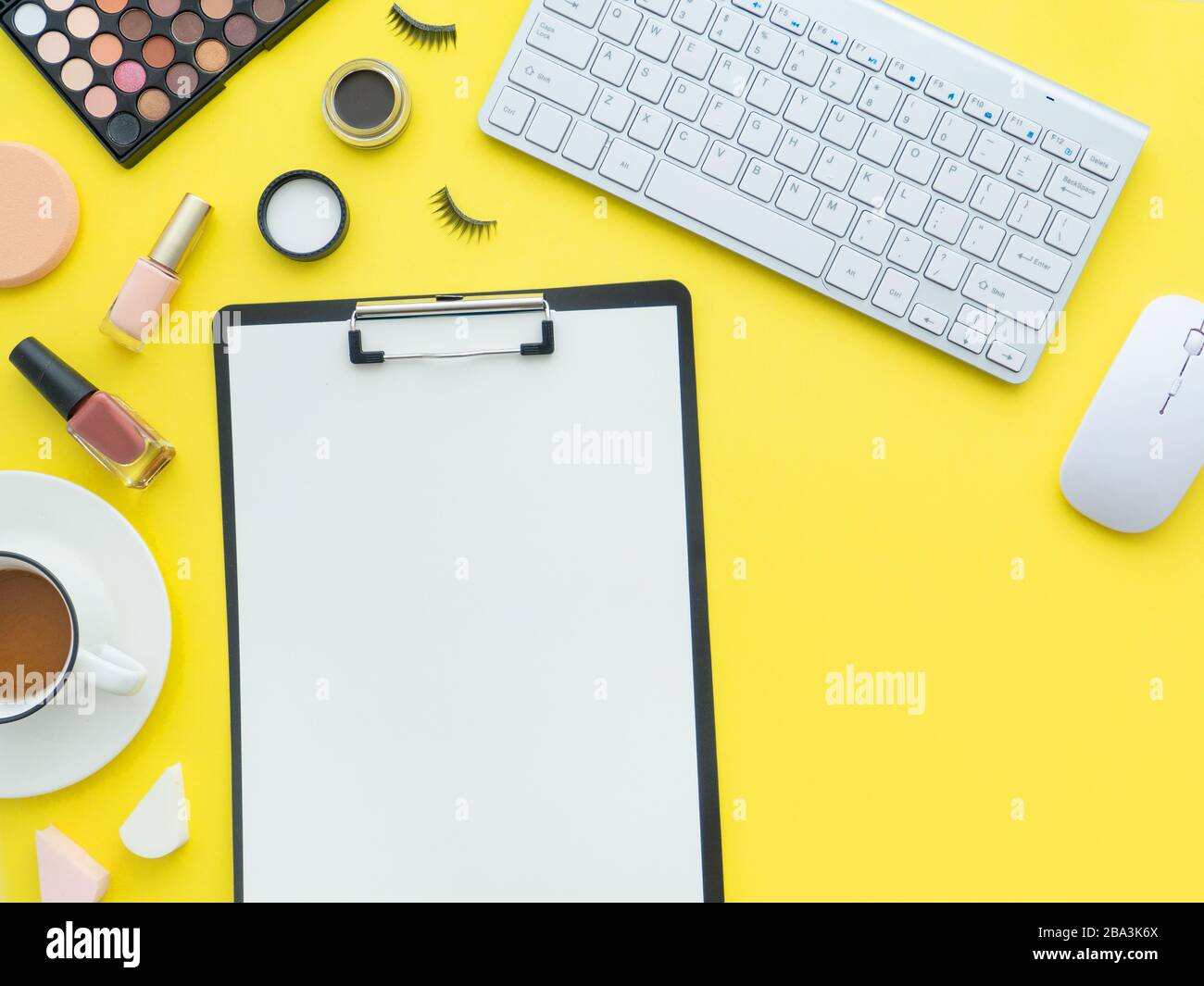 Keyboard mouse, cup of tea and makeup tools and cosmetic products ...