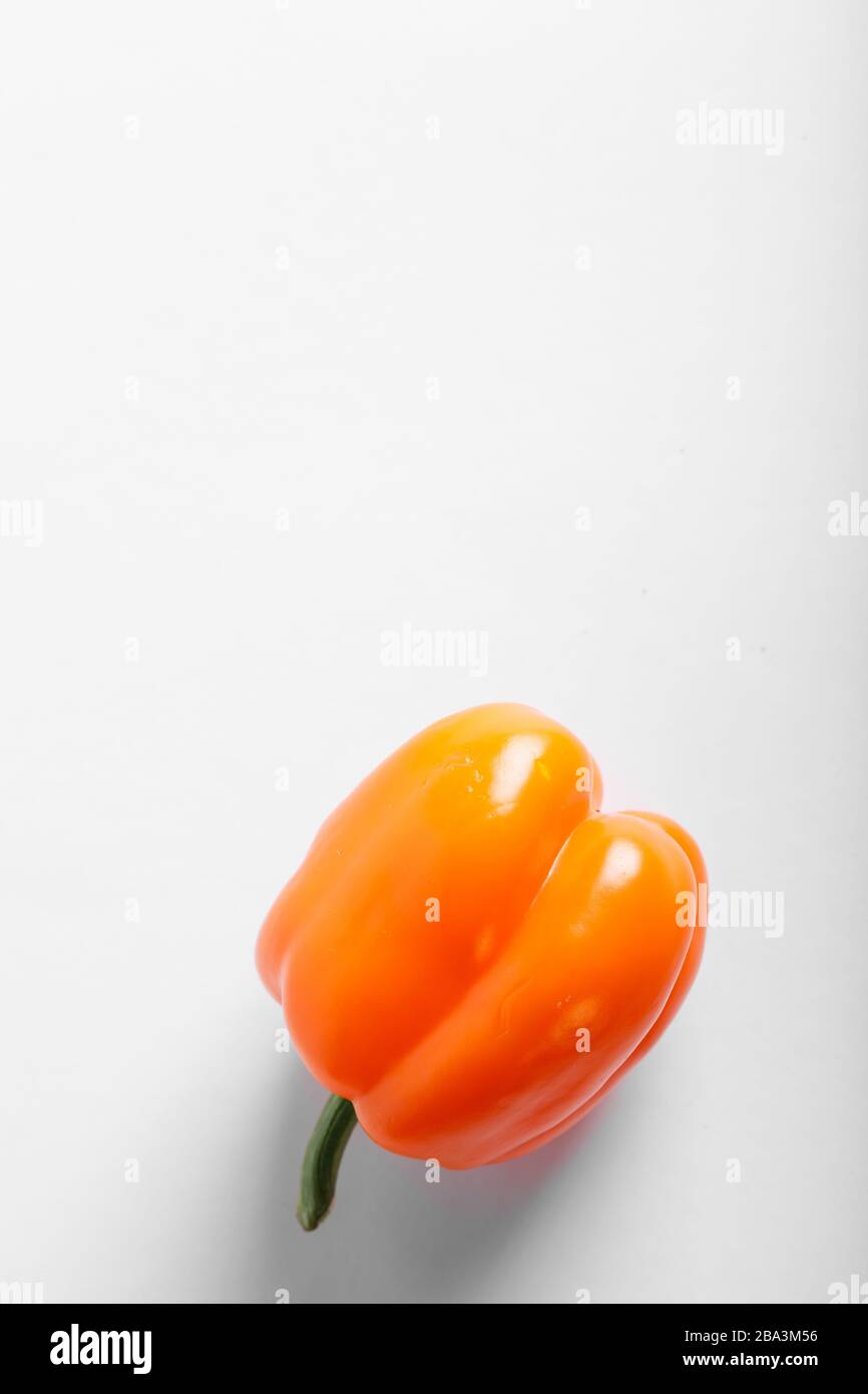 A single orange color bell pepper Stock Photo - Alamy