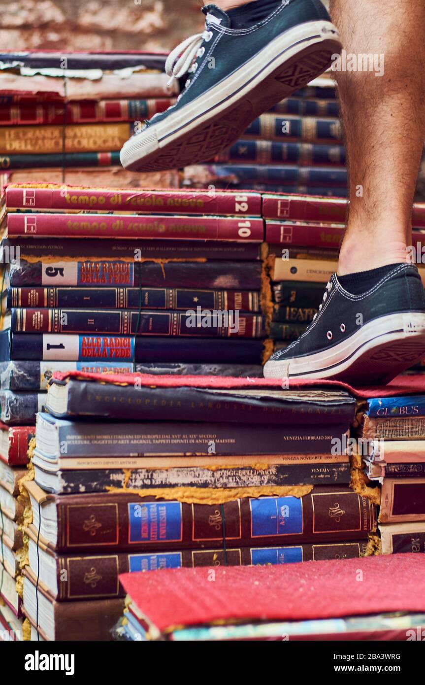Man walking on book stairs in Venice Stock Photo - Alamy