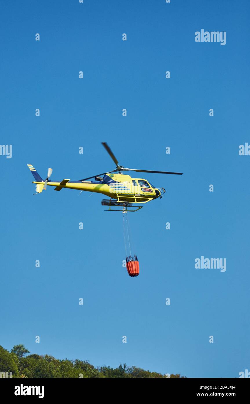 Helicopter refilling tank of water during fire Stock Photo - Alamy