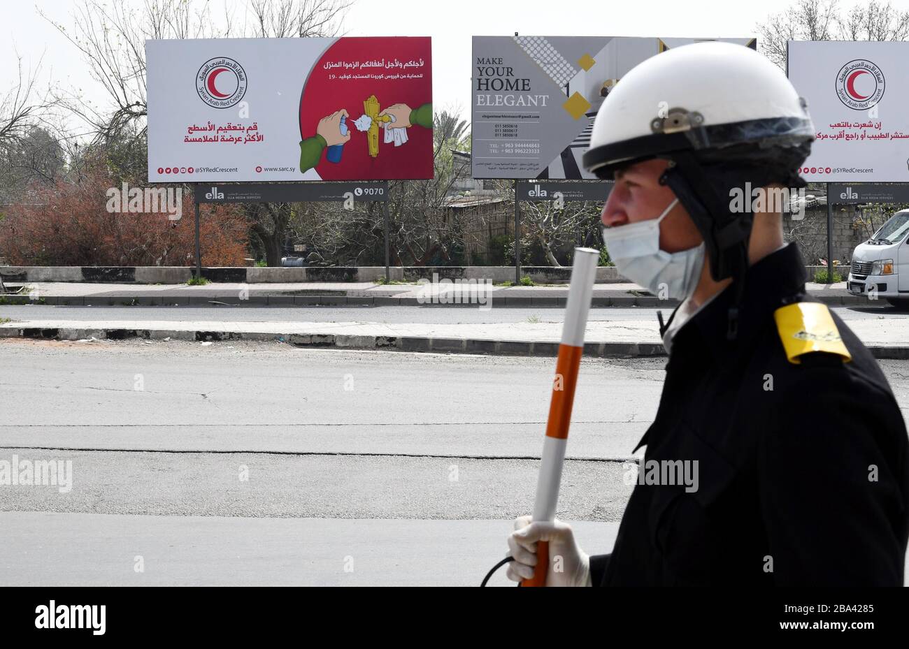 Damascus, Syria. 25th Mar, 2020. A traffic policeman wearing a face ...
