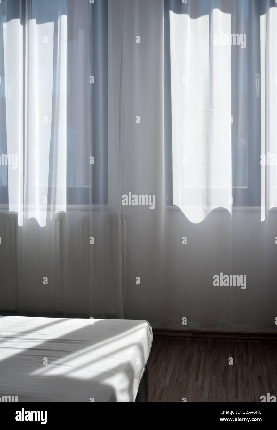 Sunlight falling into a room with a bed Stock Photo - Alamy
