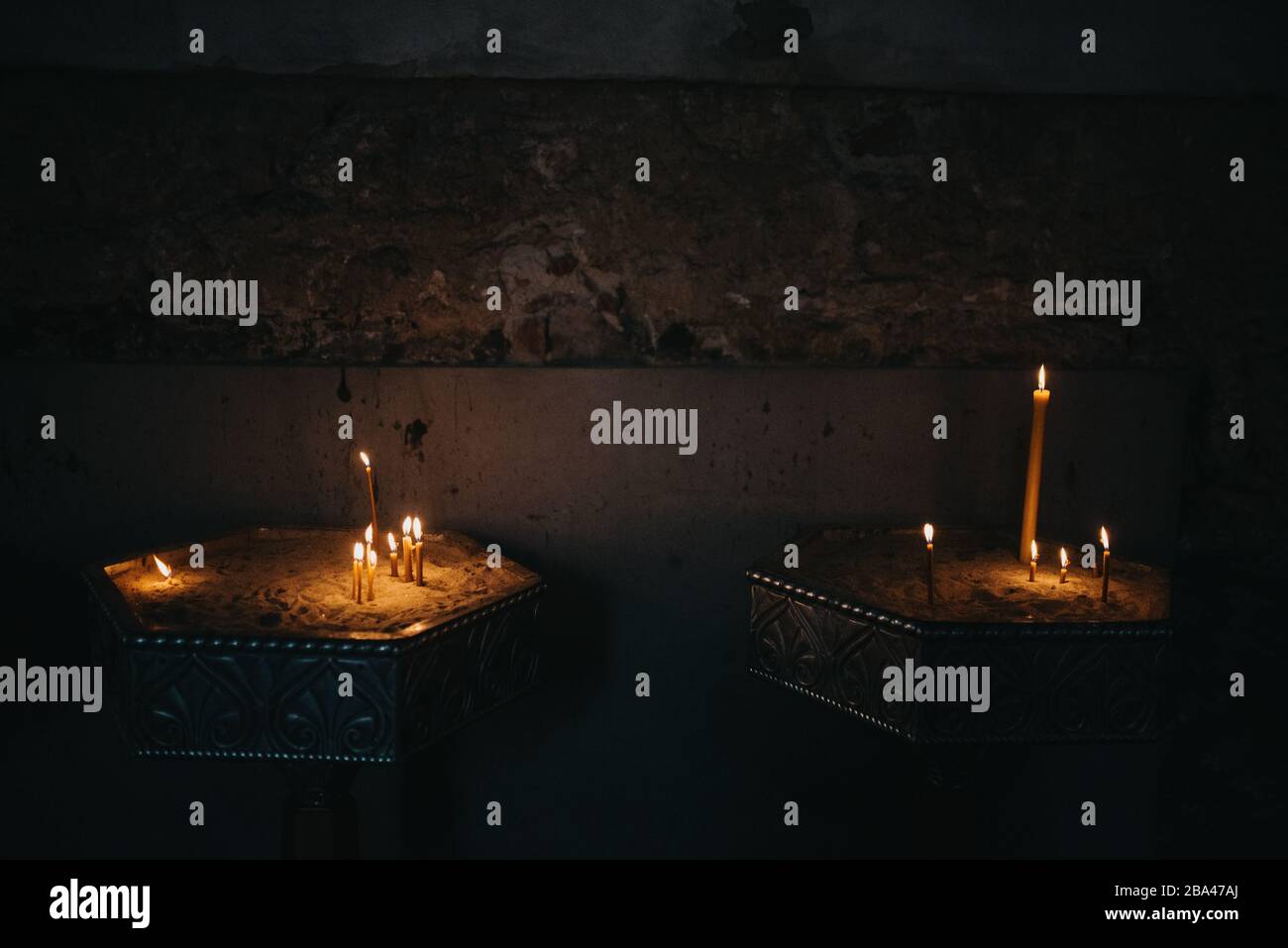 Candles lit in church. Light in the darkness Stock Photo - Alamy