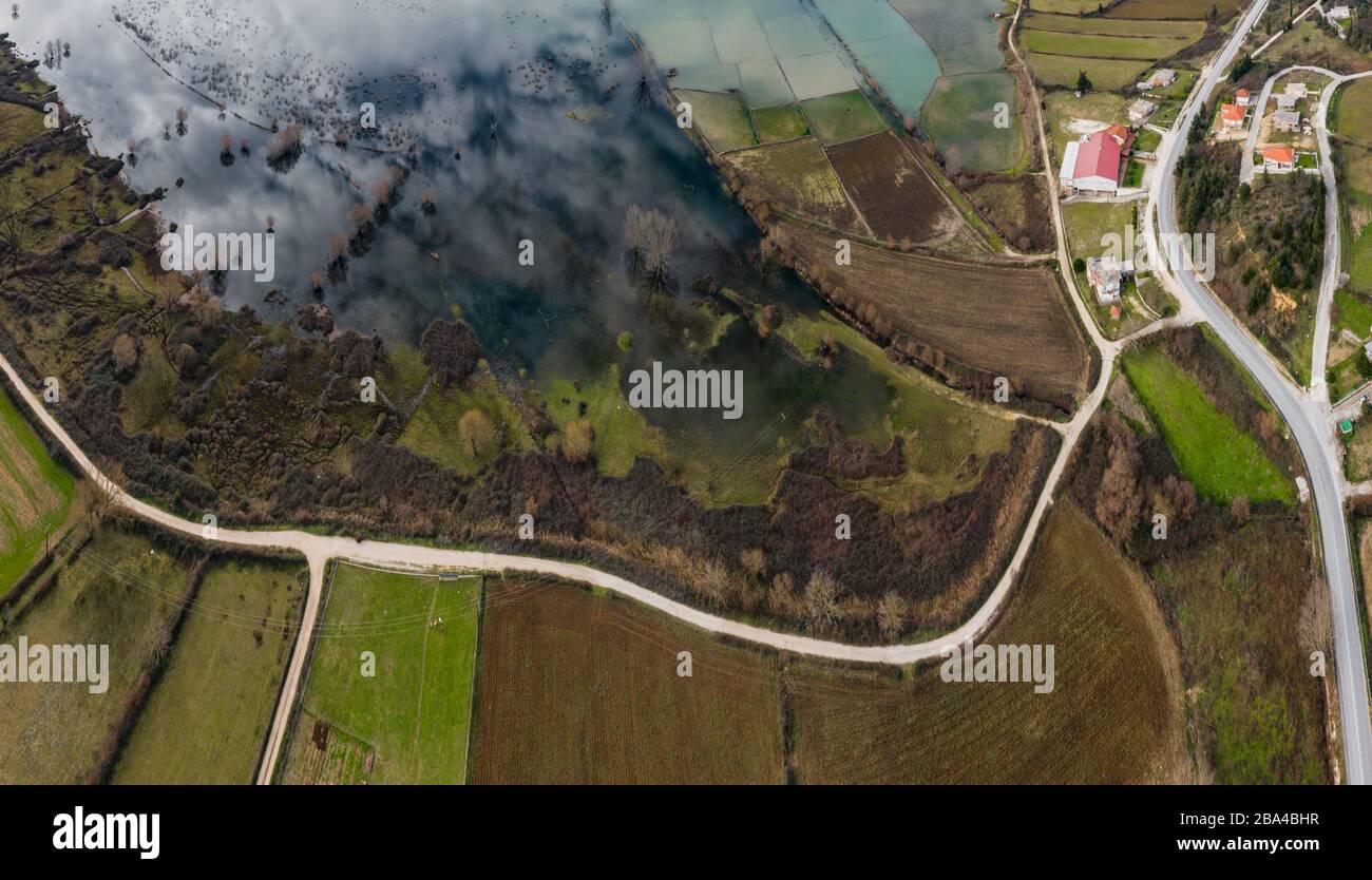 Flight over the flooded valley in Greece. The flooded fields, roads ...