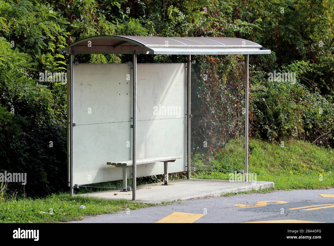 Metal and clear transparent glass modern bus station with wooden bench ...