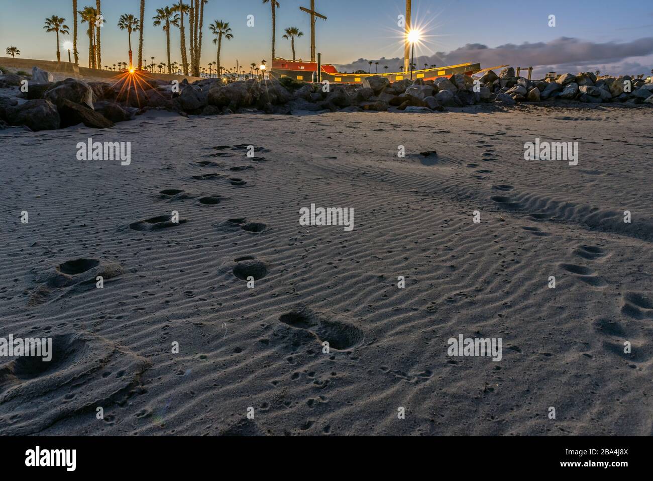 Sand texture shows as dawn sky casts long shadows on wavy pattern in ...