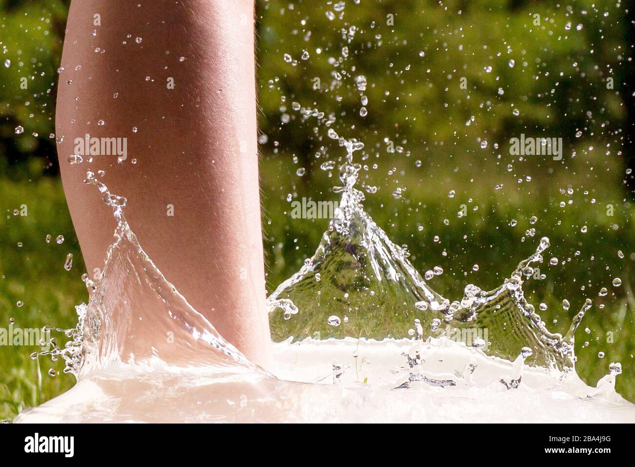Children playing in sprinkler hi-res stock photography and images - Alamy