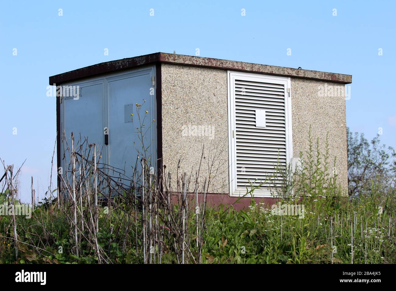 Small local electrical substation building with large front metal ...