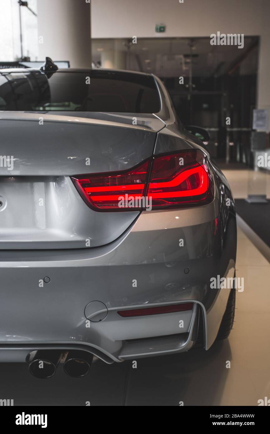 Back pipes and red xenon lights of a silver car Stock Photo - Alamy