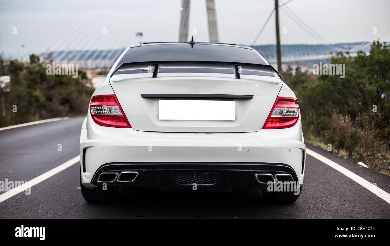 White business class sedan parked on the road. Place with a view Stock ...