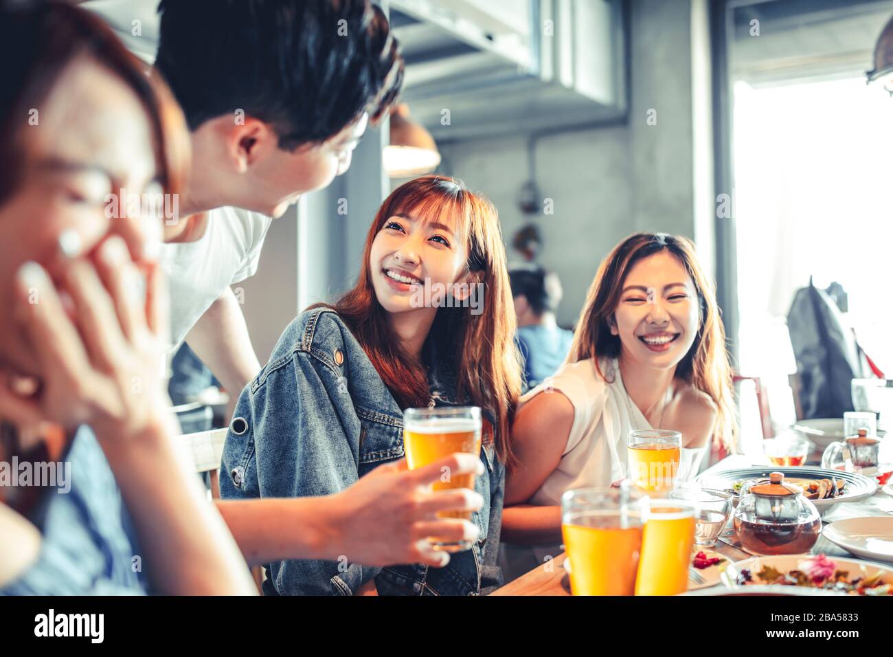 happy young friends dining and drinking beer at restaurant Stock Photo ...