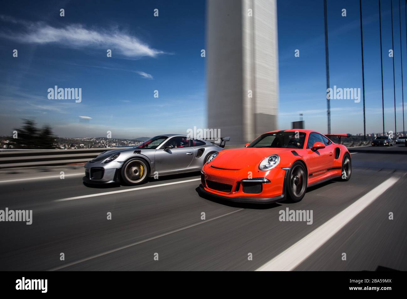 Red and silver sport cars on the road Stock Photo - Alamy