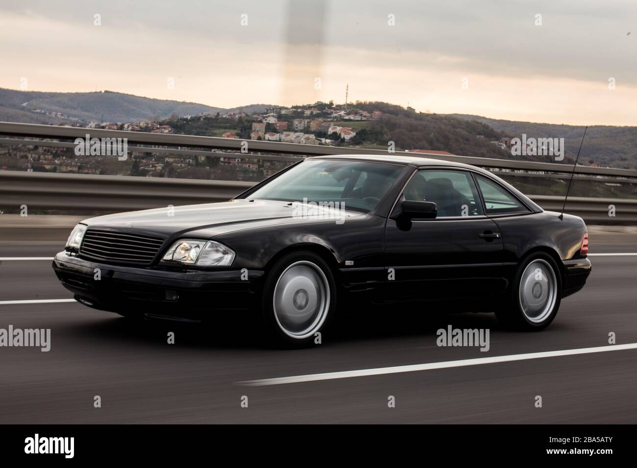 Black sedan car high speed drive on the highway Stock Photo - Alamy