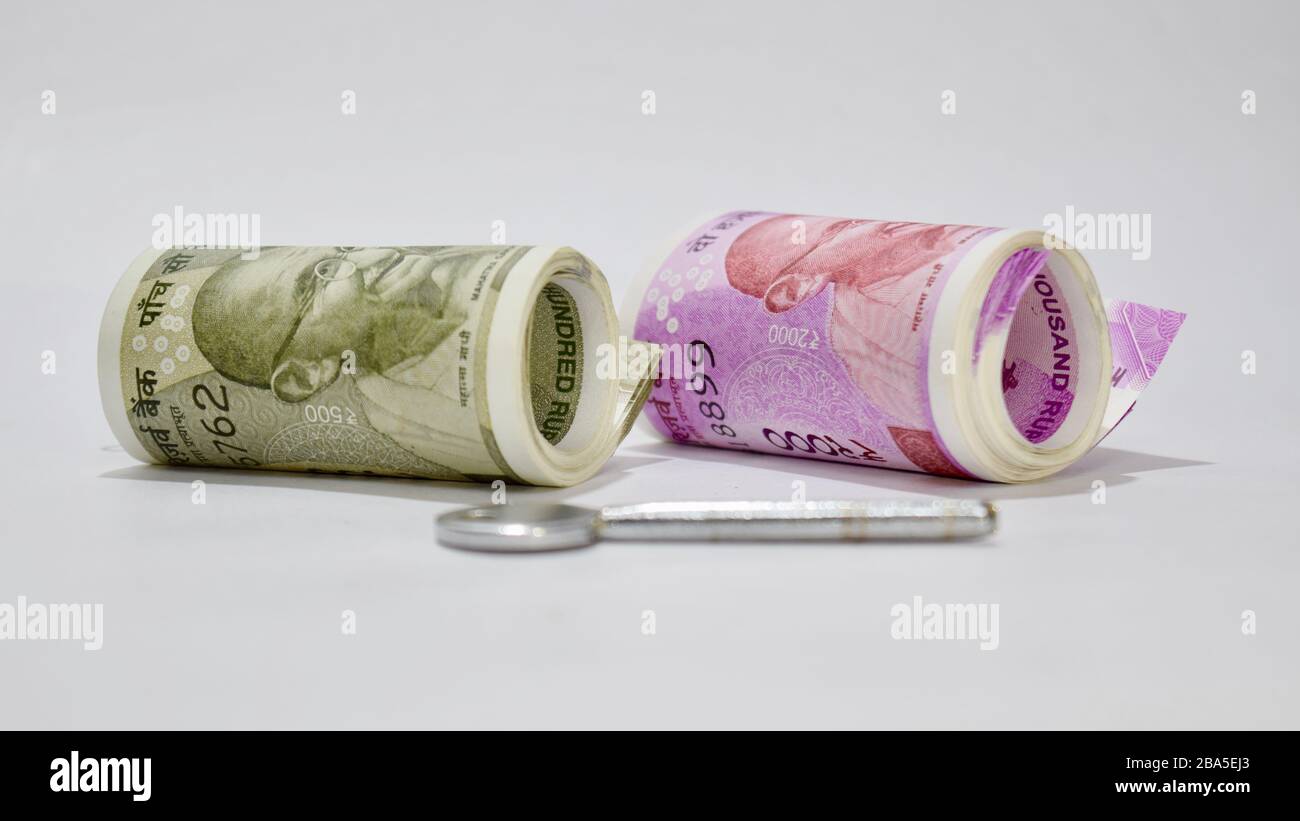 View of Rolled indian paper currency and key Stock Photo - Alamy