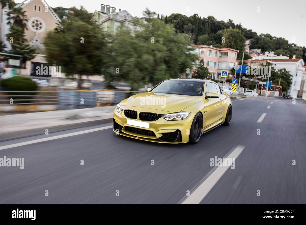 Golden luxury sport car high speed drive on the highway Stock Photo - Alamy