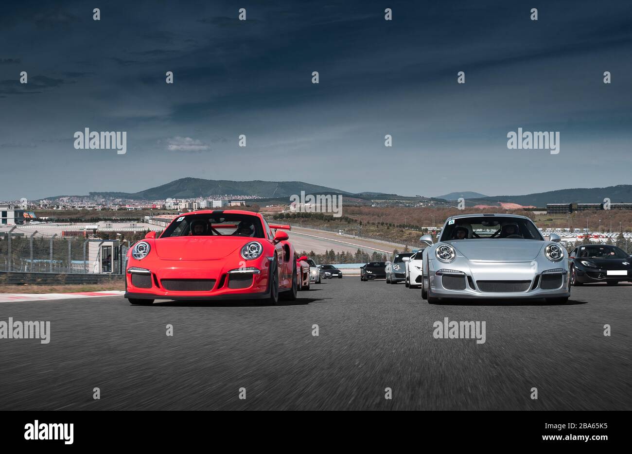 Multiple sport cars on the race trace passing each other Stock Photo ...