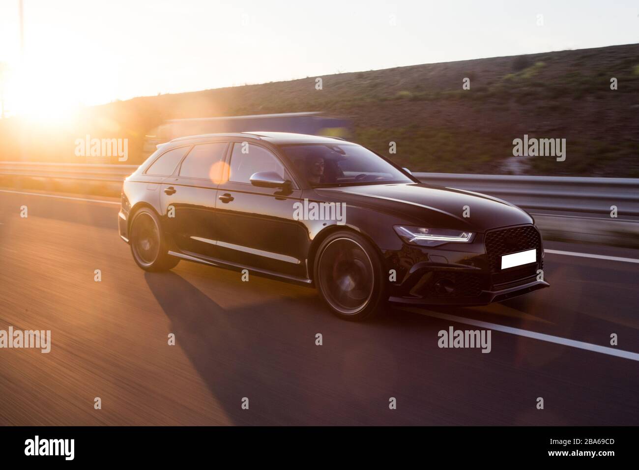 Black business class hatchback in the sunset Stock Photo - Alamy