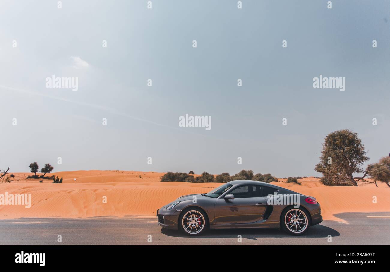 Driving a sport car through the desert Stock Photo - Alamy