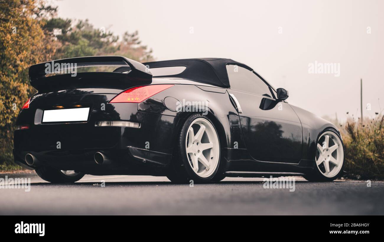 Back view of a luxury black sport car Stock Photo - Alamy