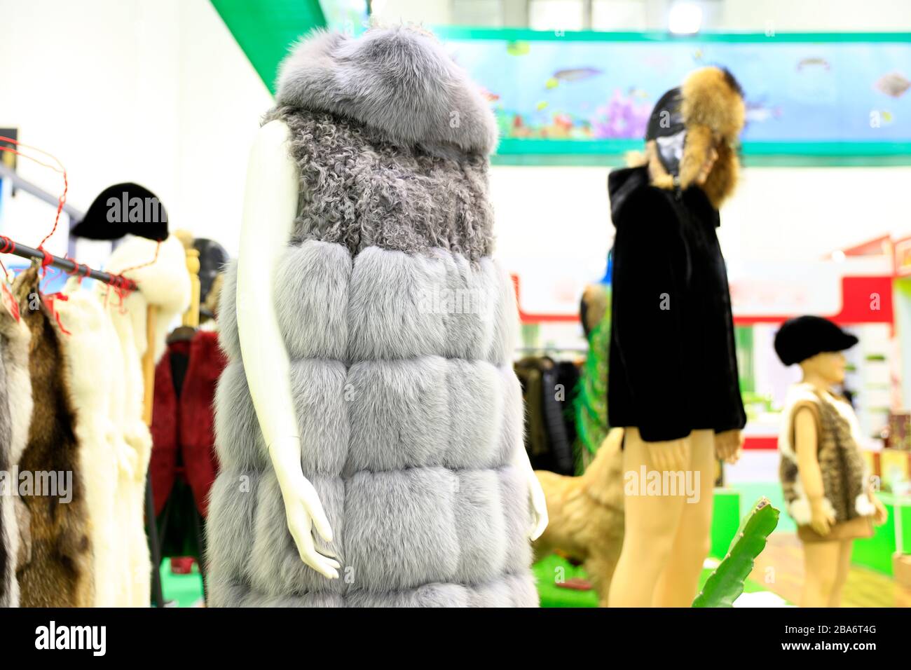 Luxury fur coats hanging on rack, various colors of mink, fox and sheep ...