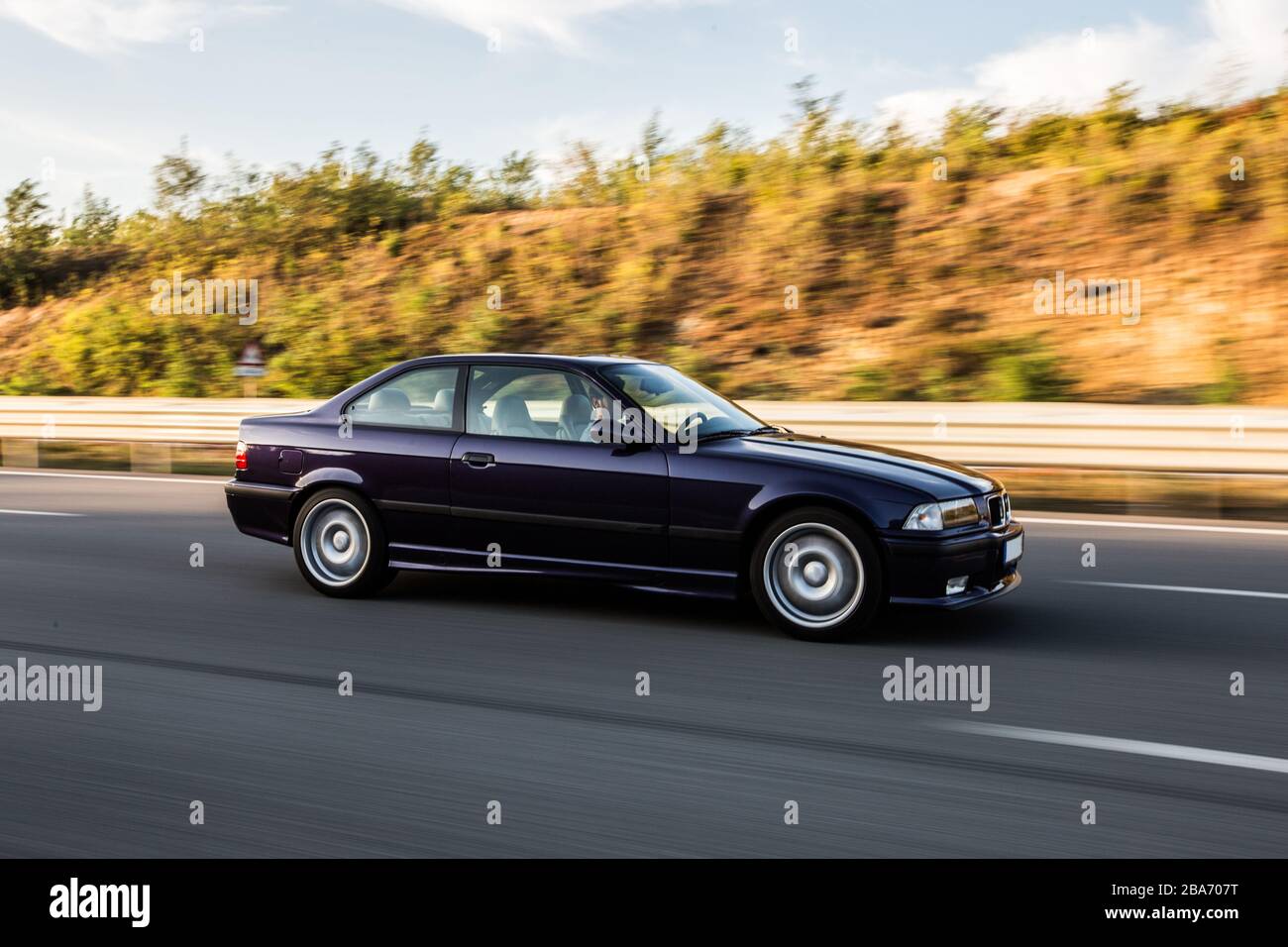 Driving an old model vintage car on the highway Stock Photo - Alamy