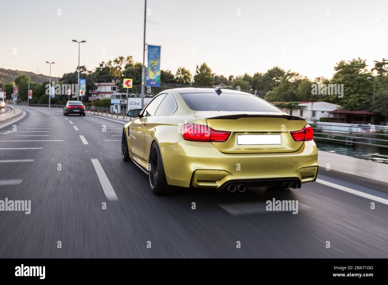 Golden luxury sport sedan, back view Stock Photo - Alamy