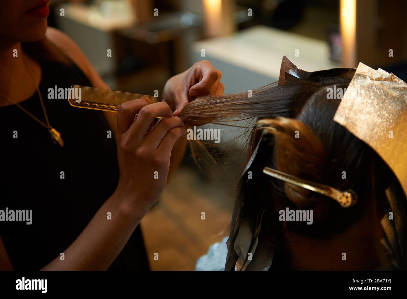 Cutting and coloring hair at a salon Stock Photo - Alamy