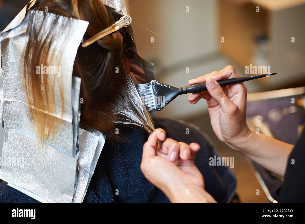 Cutting and coloring hair at a salon Stock Photo - Alamy