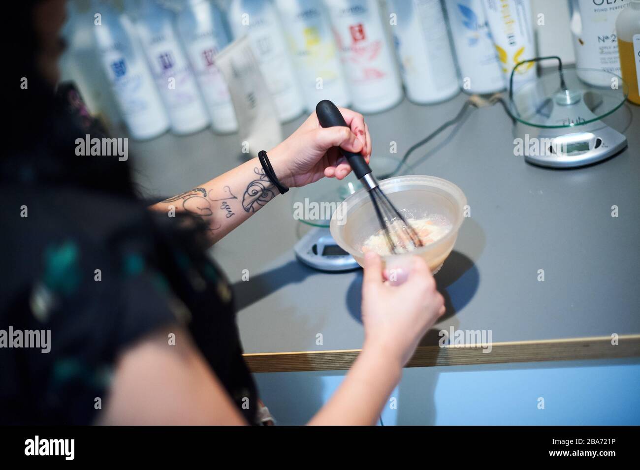 Woman mixing hair color at a salon Stock Photo - Alamy