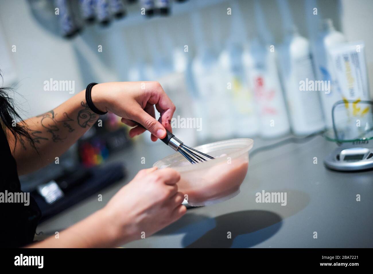 Woman mixing hair color at a salon Stock Photo - Alamy