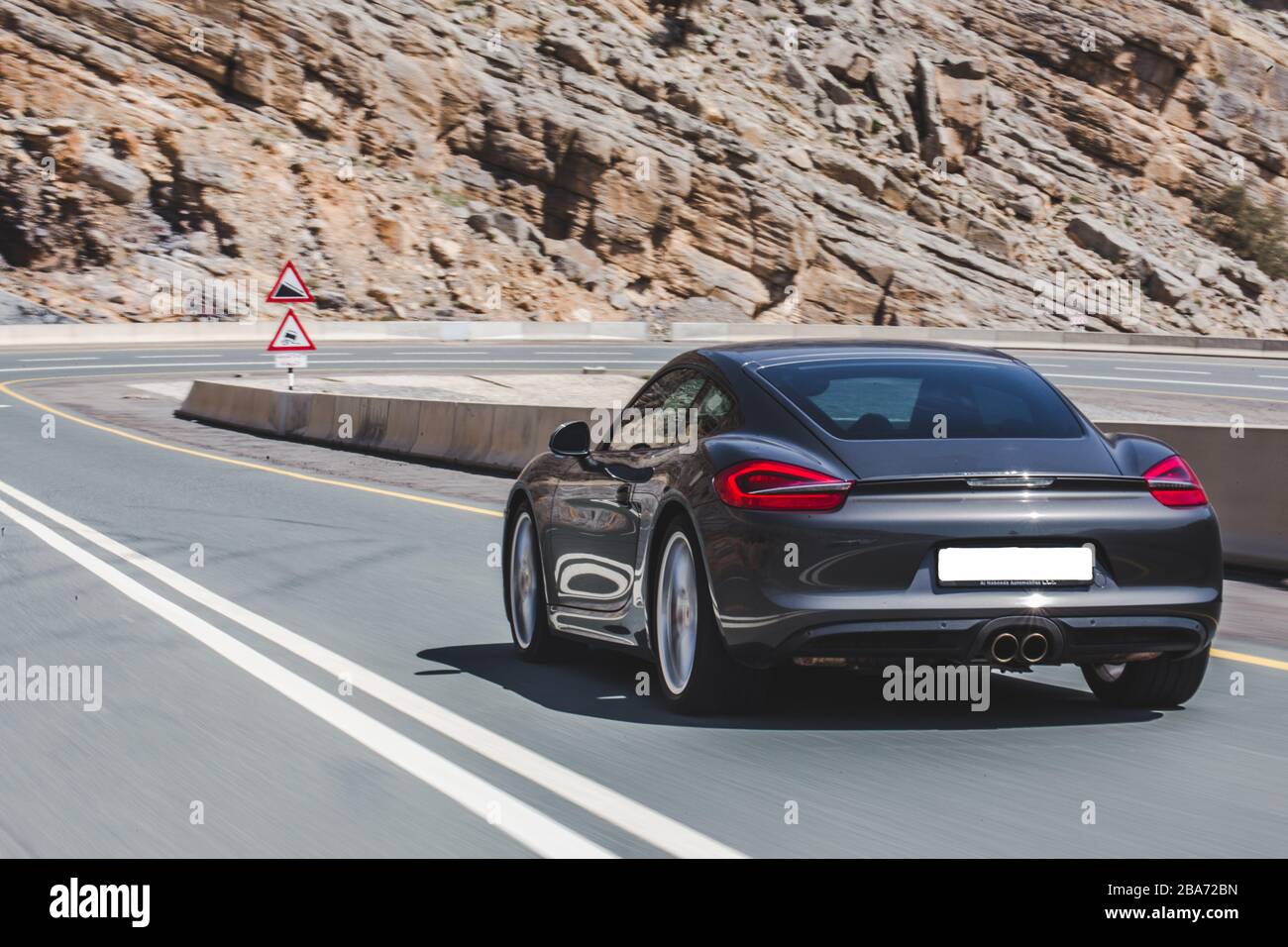 Driving a grey color sport car in the mountian under the sun Stock ...