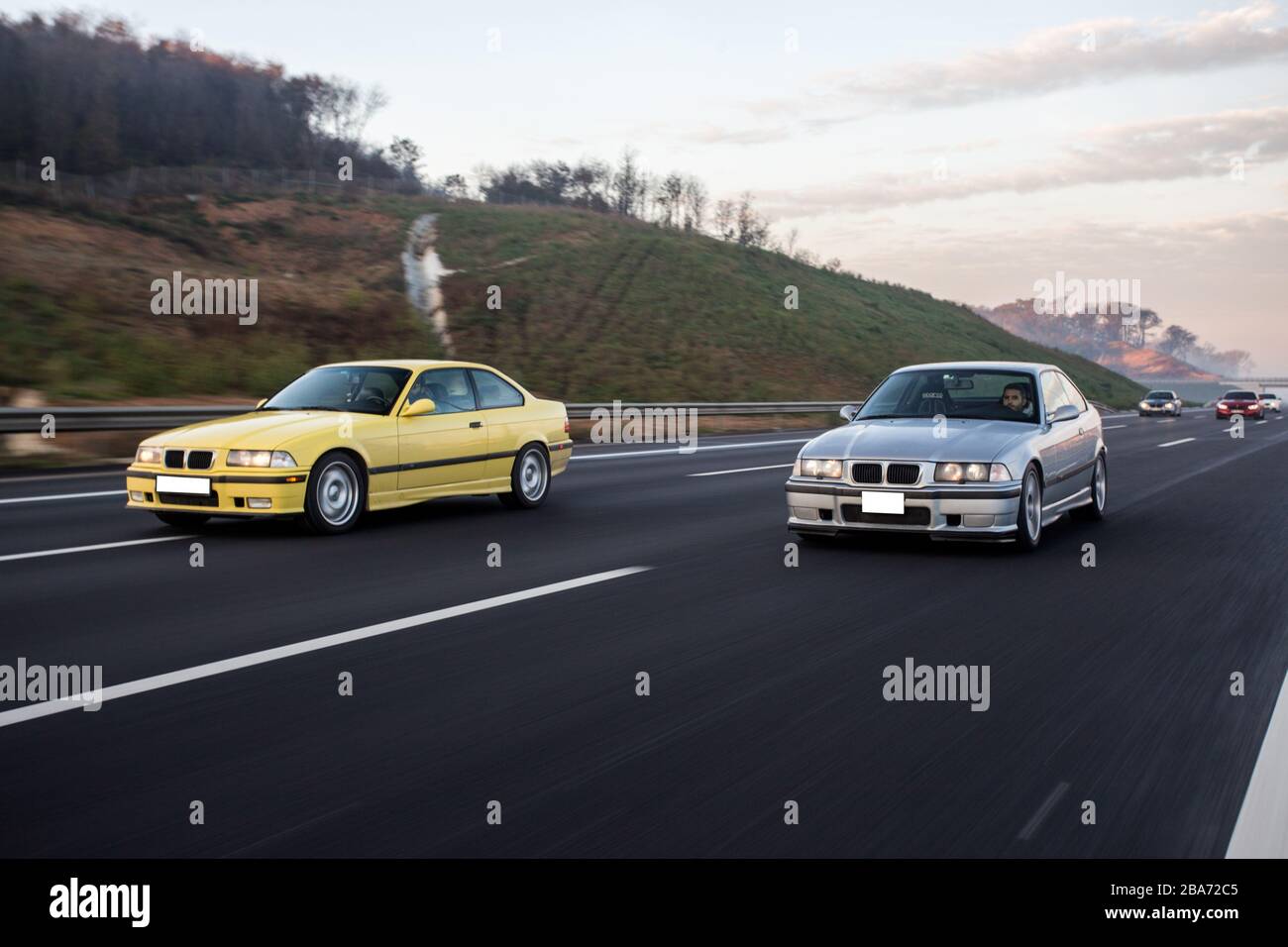Yellow and silver sport cars race Stock Photo - Alamy