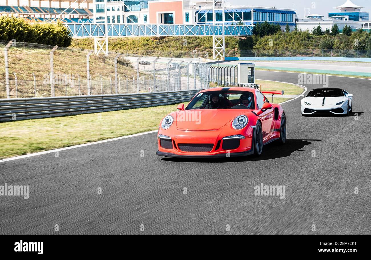 Red sport car on a countryside highway Stock Photo - Alamy