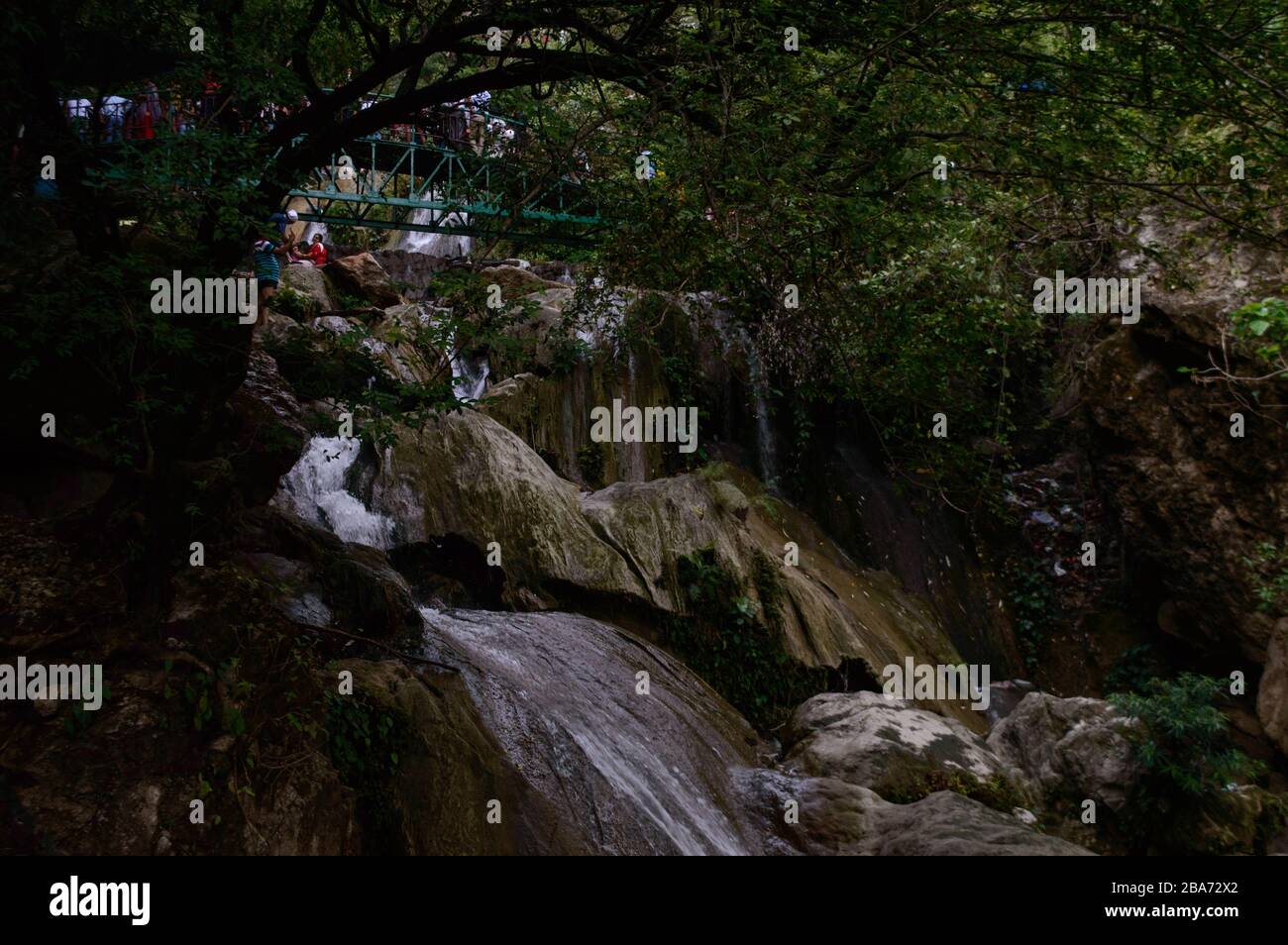 Group of people enjoying under the famous neer garh Waterfall ...
