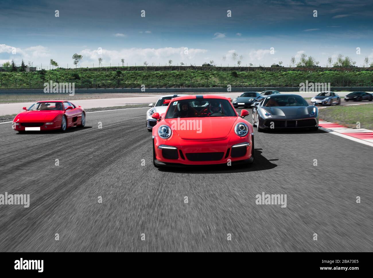 Multiple sport cars on the race trace Stock Photo - Alamy