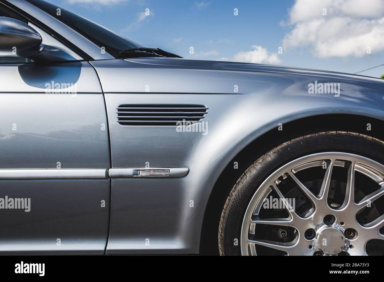 Front wheel and window of a silver car Stock Photo - Alamy