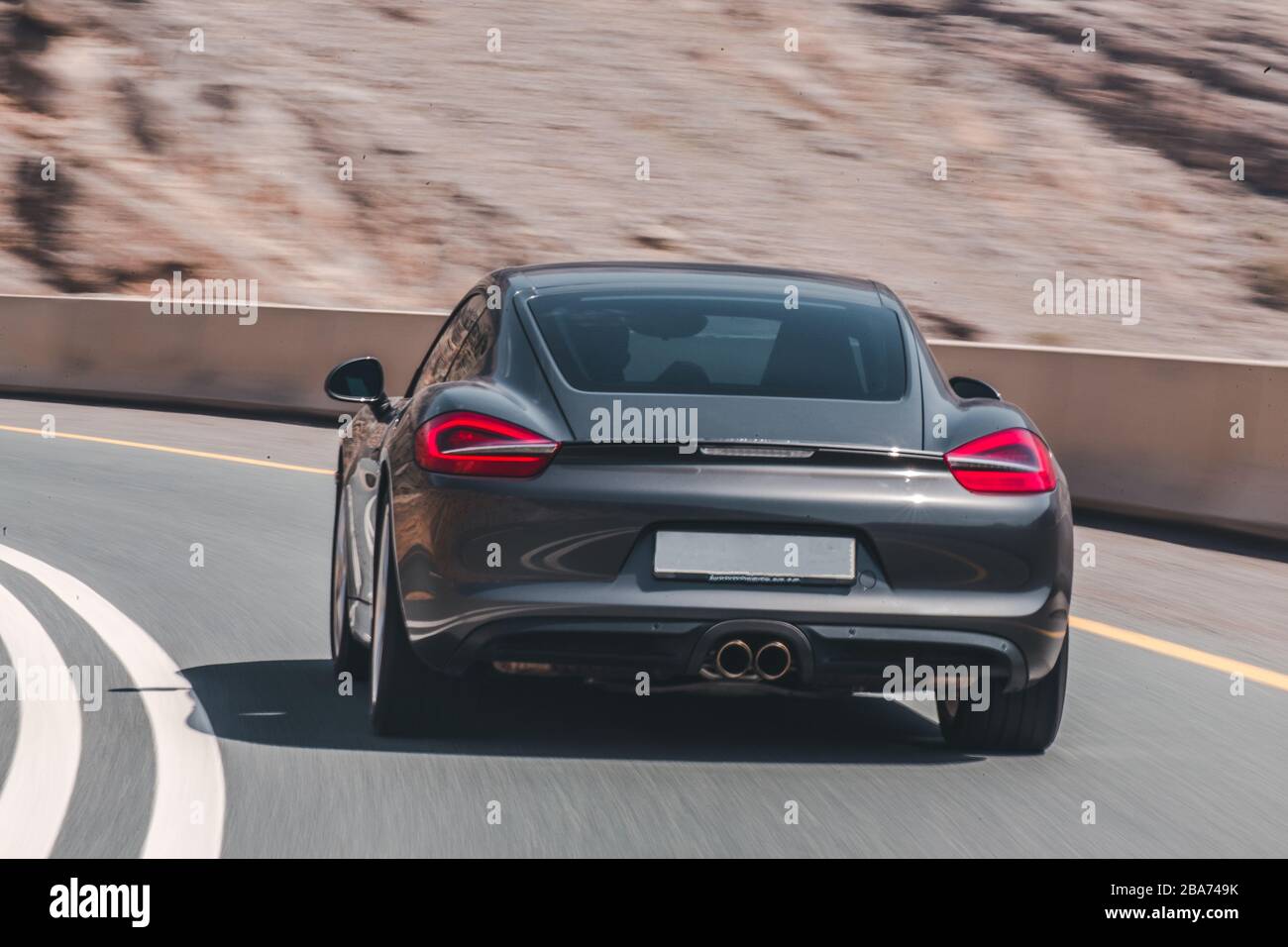 Driving a grey color sport car in the mountain road Stock Photo - Alamy