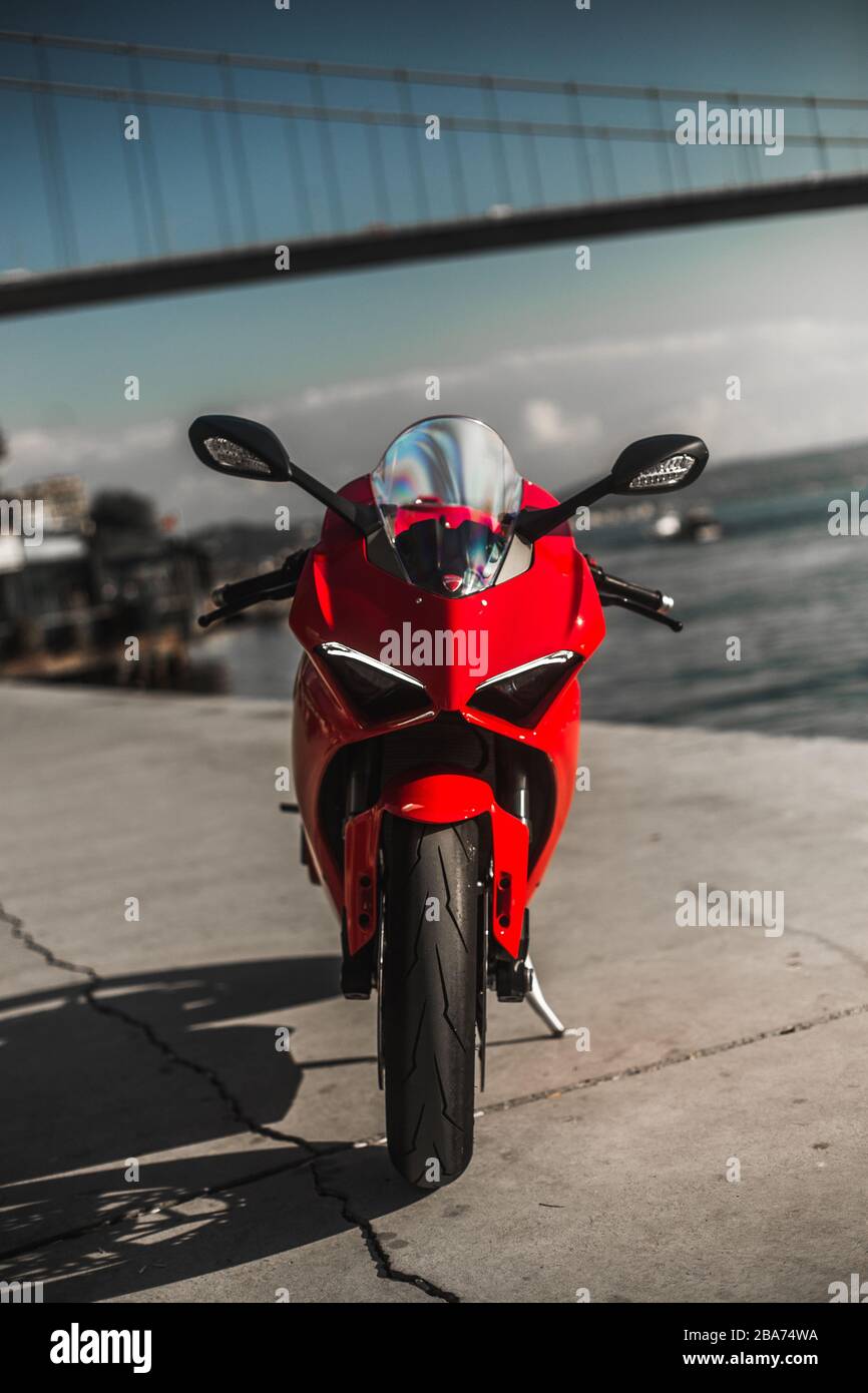 Red brand motorcycle at the seaside, front view Stock Photo - Alamy