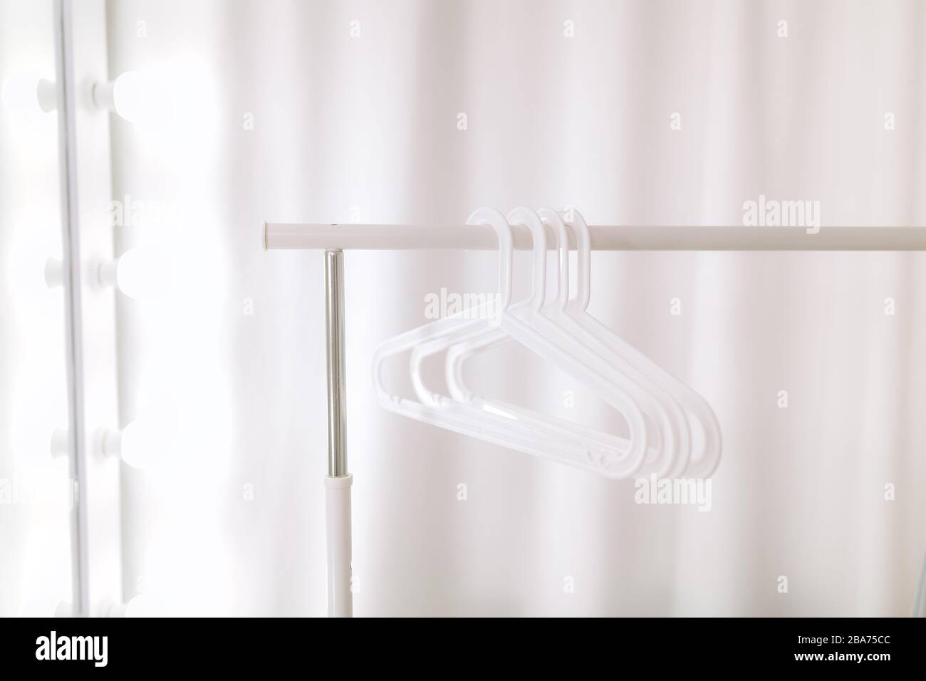 Stylish white hangers Stock Photo - Alamy