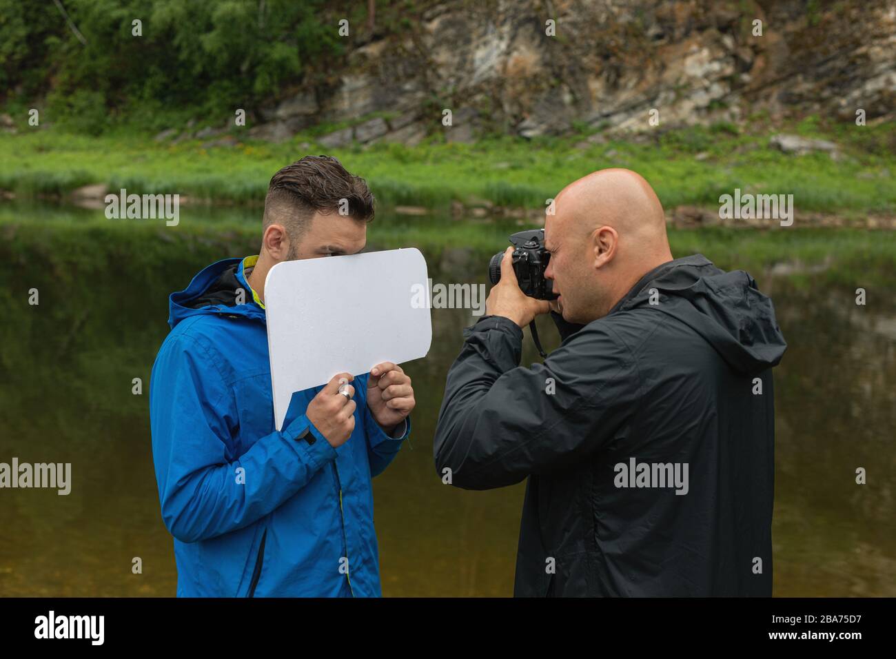 Work of photographer with model in outdoor. Photographer taking close ...