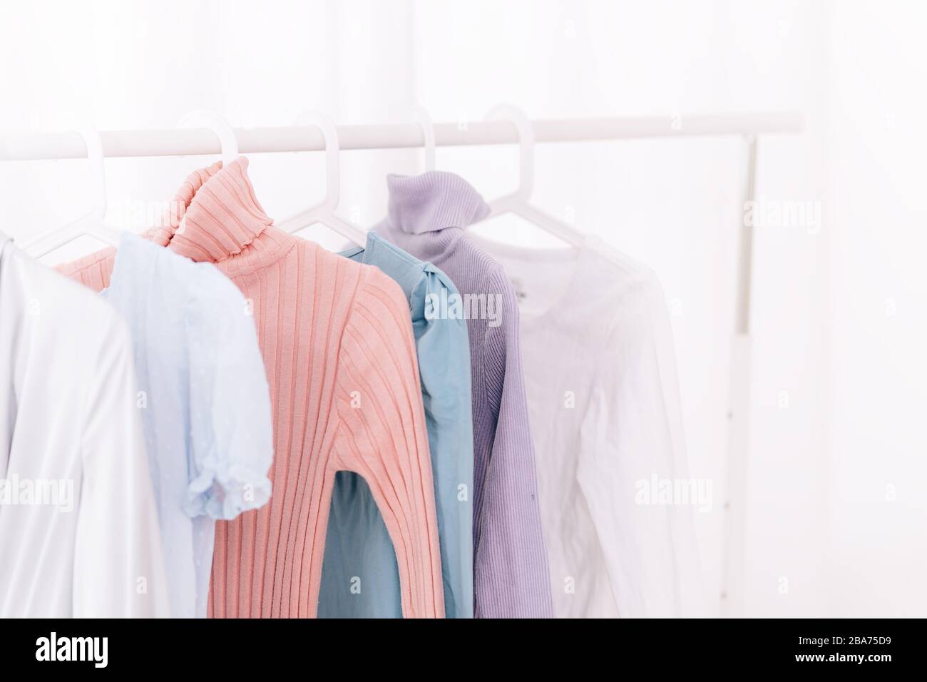 clothes hanging on hangers Stock Photo - Alamy