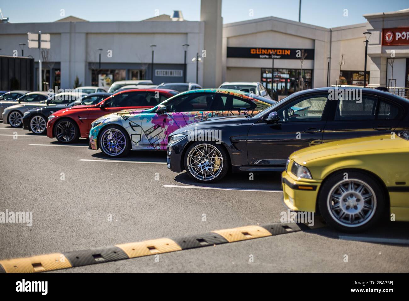 Autotuned multicolor cars parking in the gas station Stock Photo - Alamy